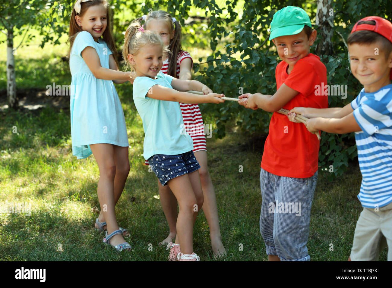 Happy active children playing in park Stock Photo - Alamy