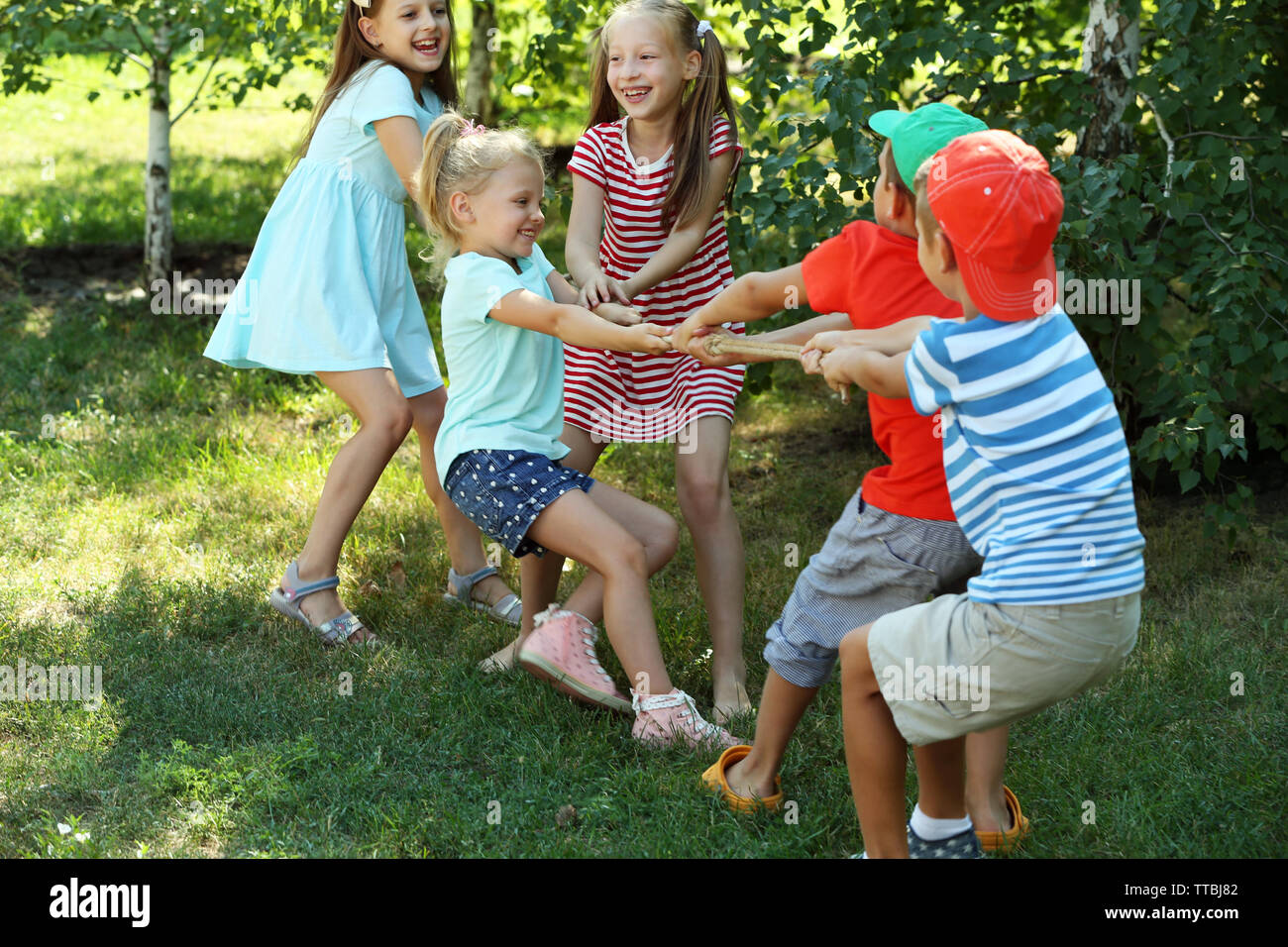 Happy active children playing in park Stock Photo - Alamy
