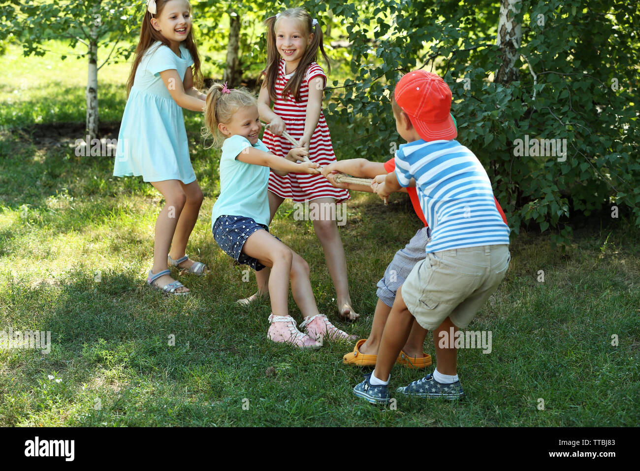 Happy active children playing in park Stock Photo - Alamy