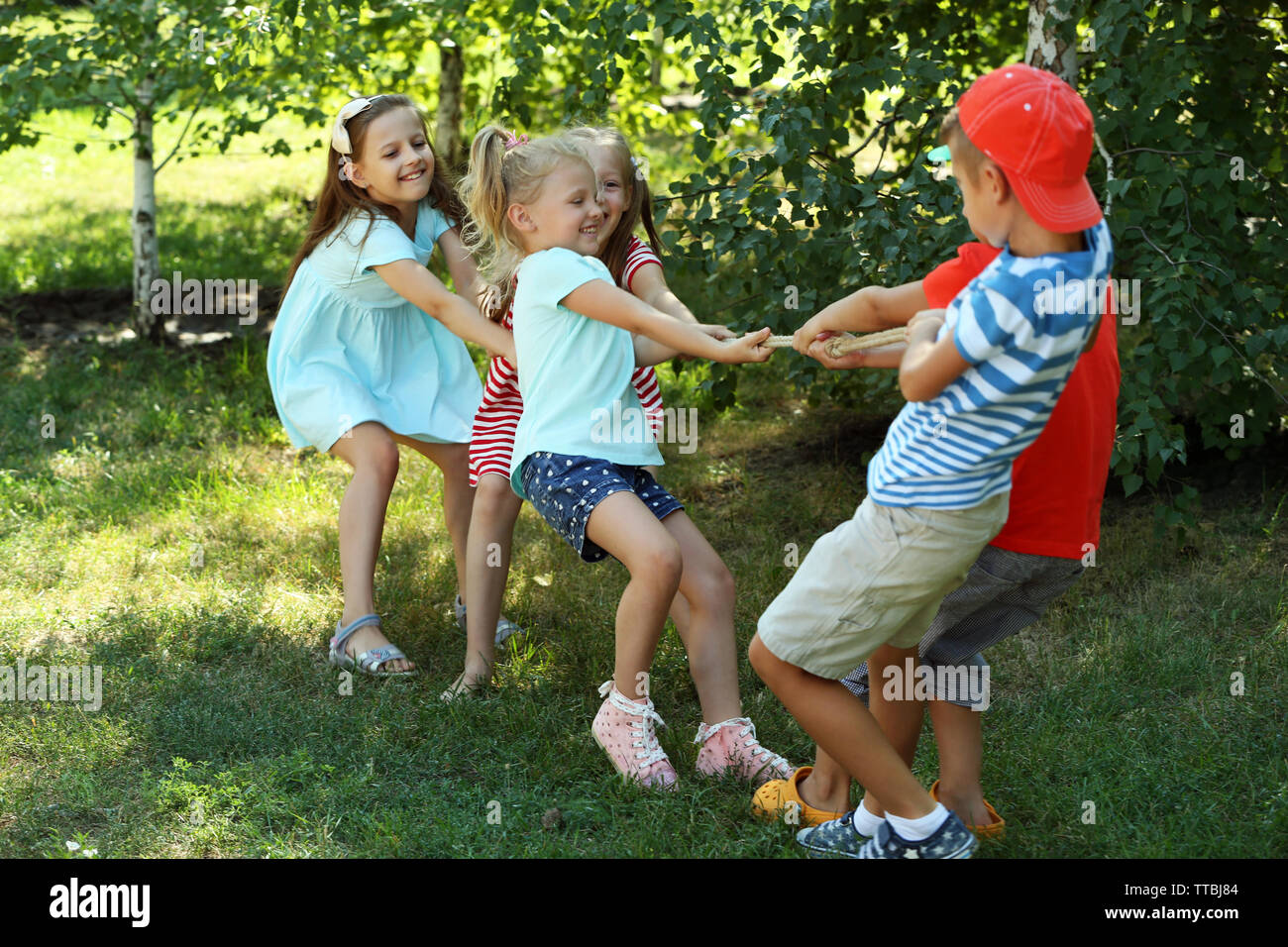 Happy active children playing in park Stock Photo - Alamy