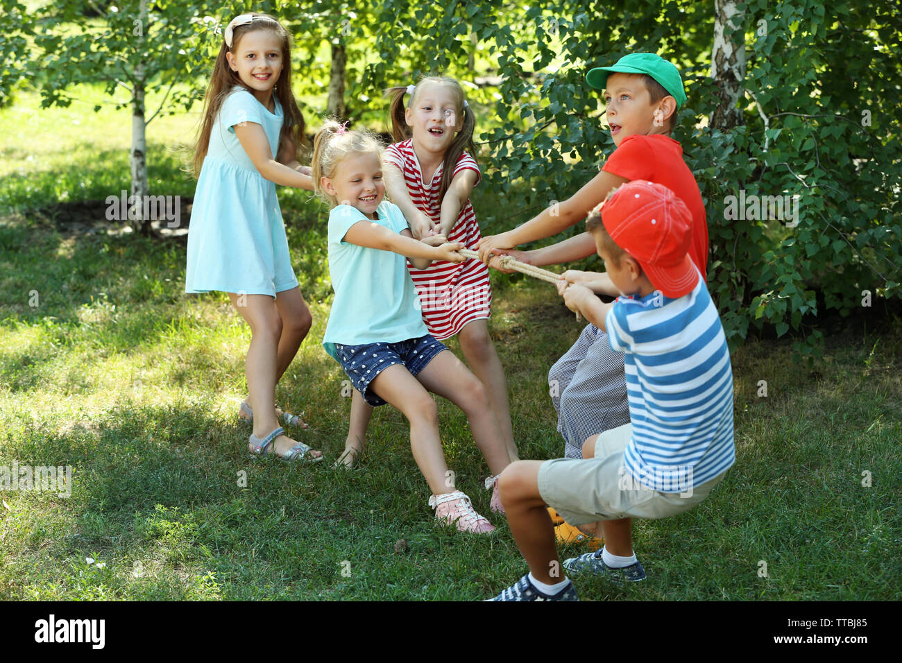 Happy active children playing in park Stock Photo - Alamy