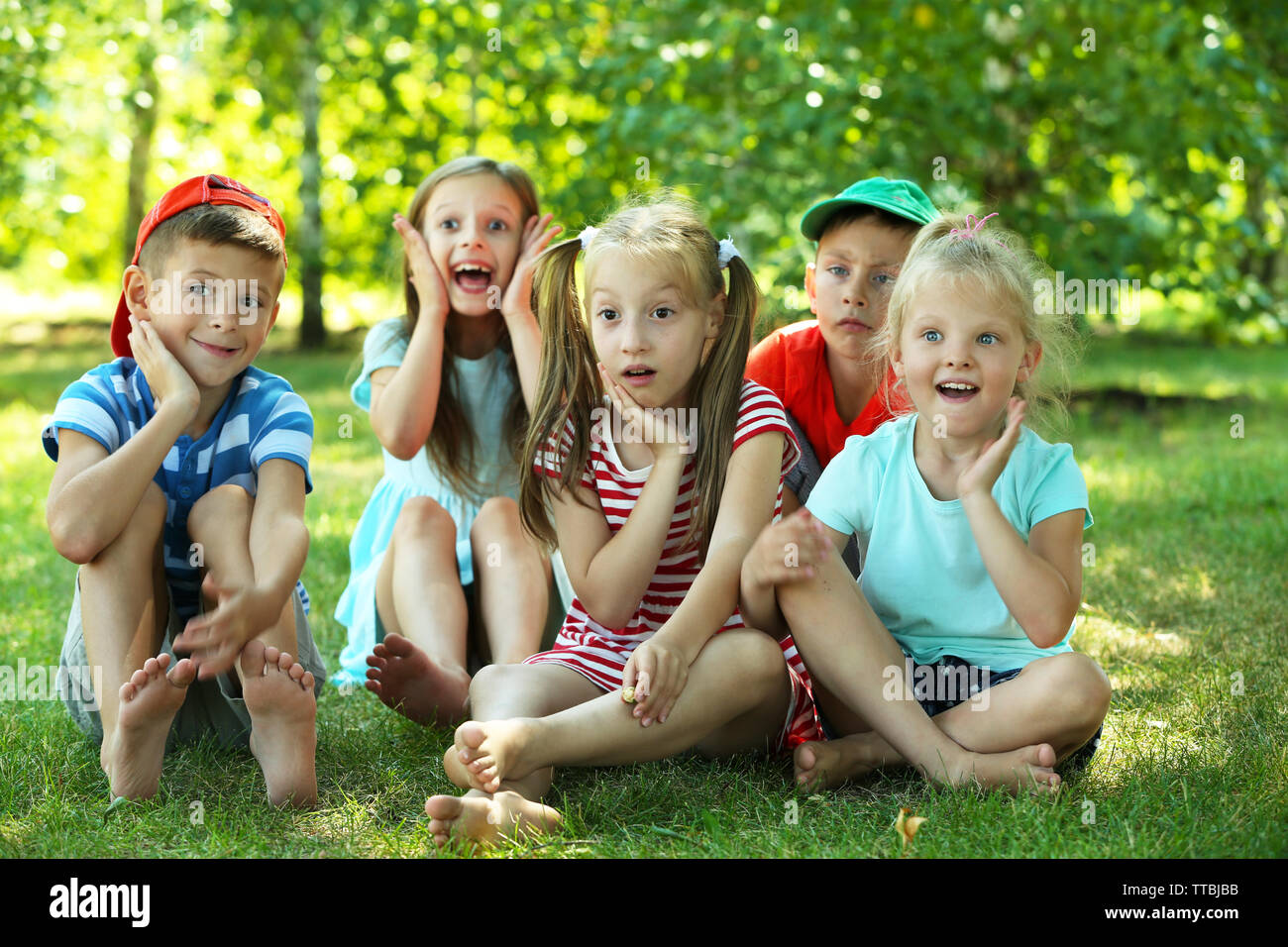 Happy active children on green grass in park Stock Photo - Alamy