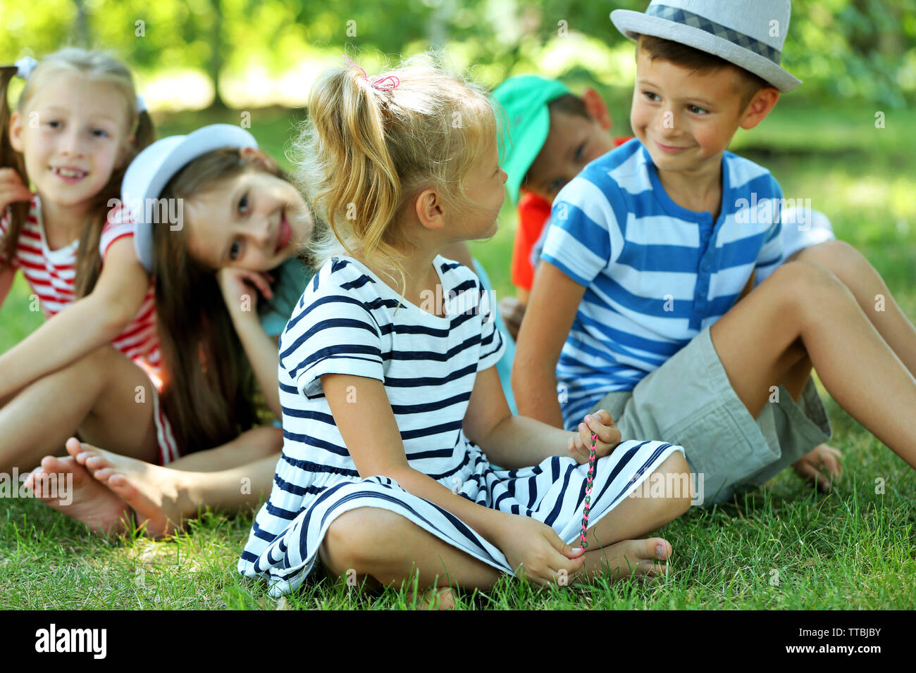 Happy active children on green grass in park Stock Photo - Alamy