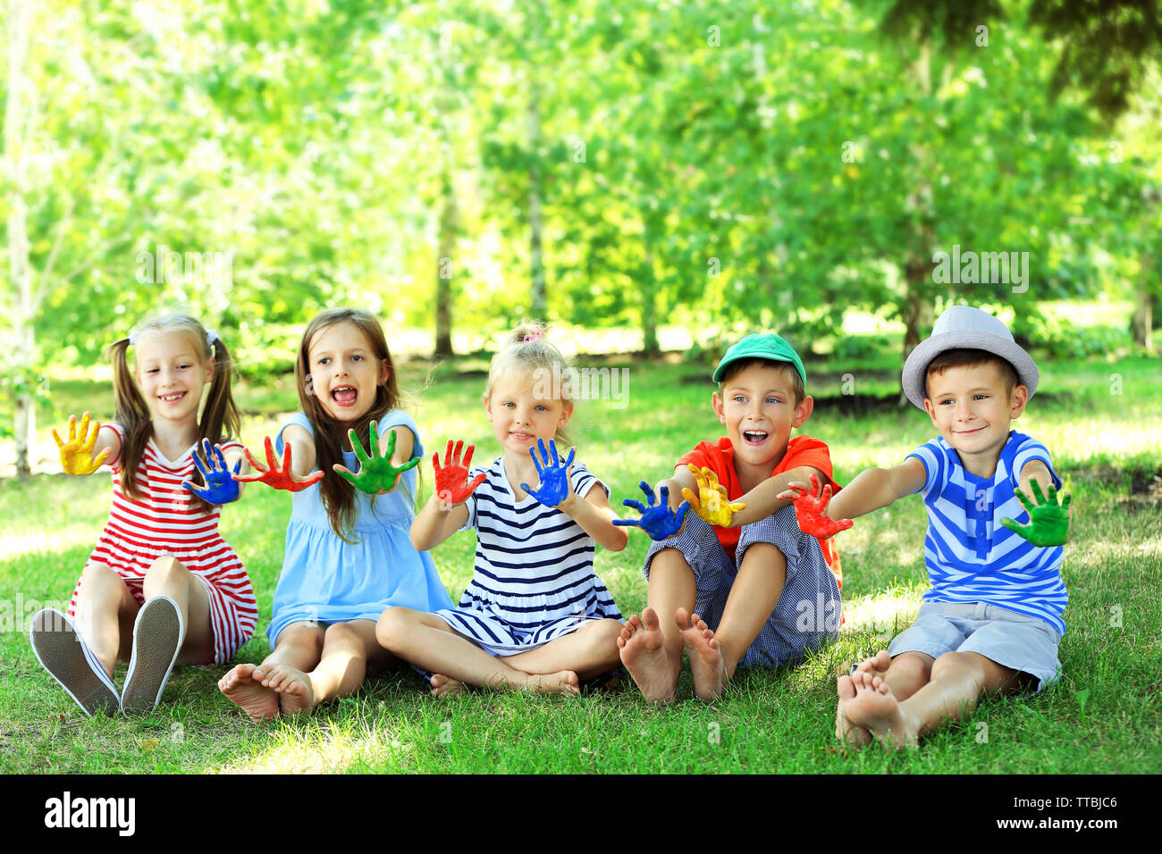Happy active children with bright colored palms in park Stock Photo - Alamy