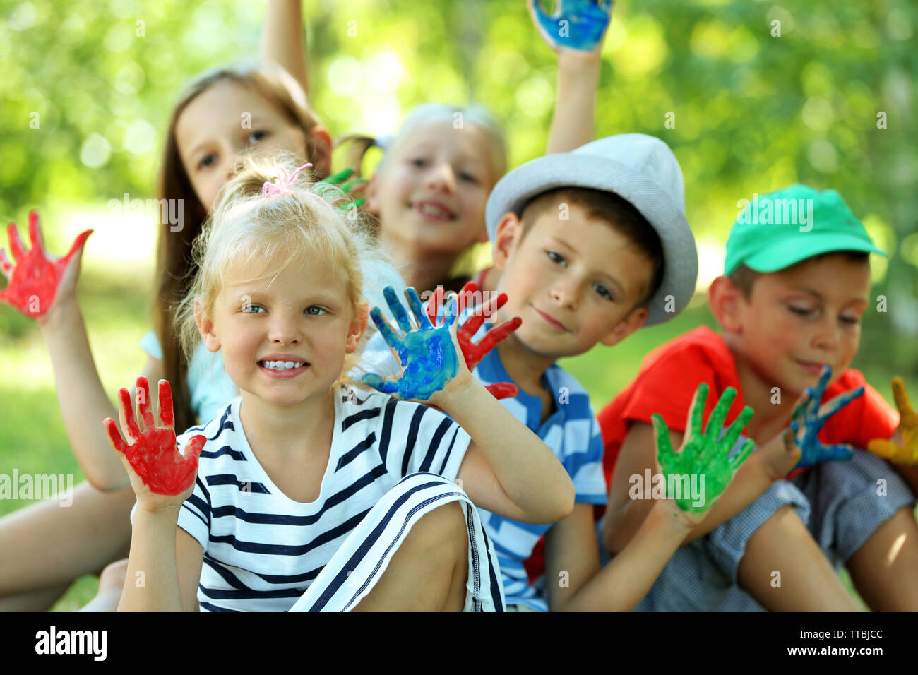 Happy active children with bright colored palms in park Stock Photo - Alamy