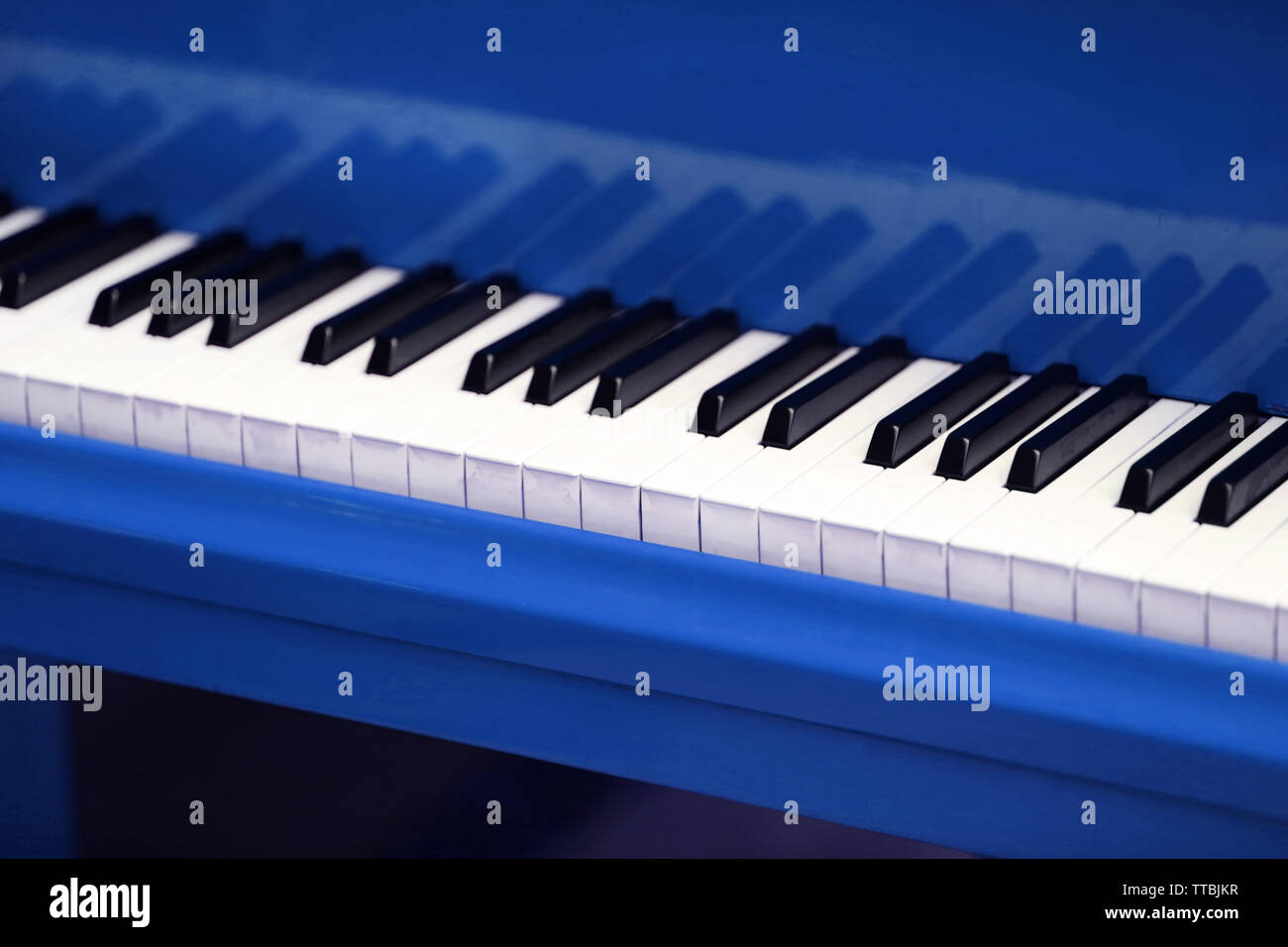 Piano keys of blue piano close up Stock Photo - Alamy