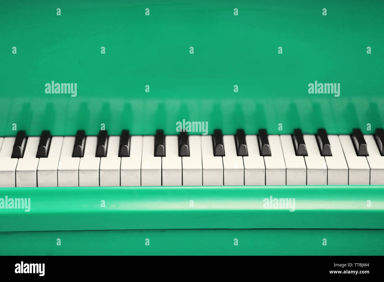 Piano keys of green piano close up Stock Photo - Alamy