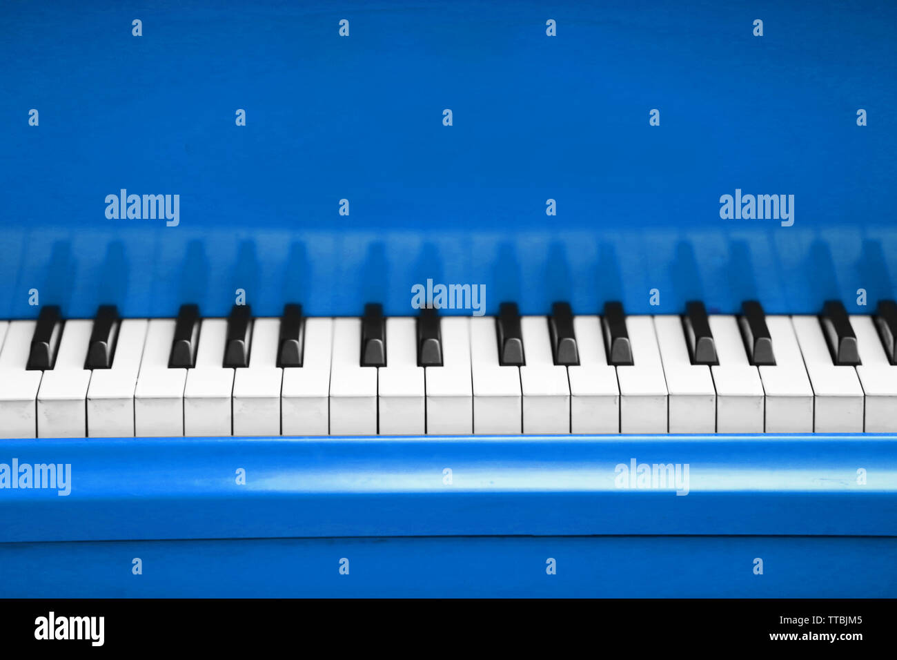 Piano keys of blue piano close up Stock Photo - Alamy
