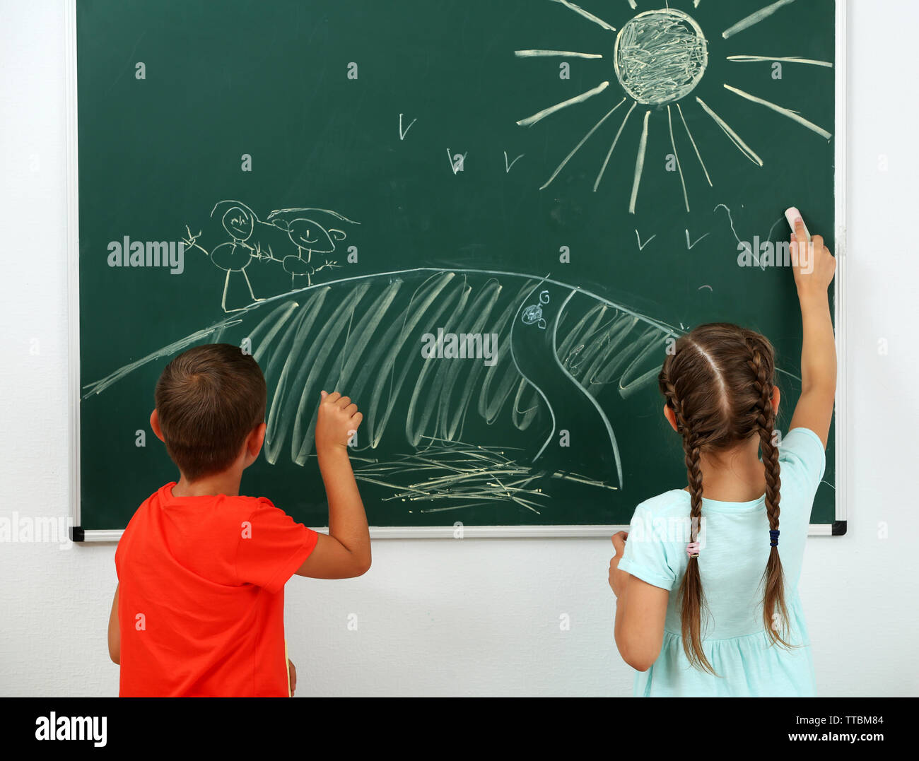 Children drawing on blackboard hi-res stock photography and images - Alamy