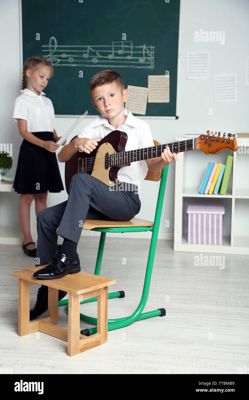 Cute pupils having music lesson in classroom at elementary school Stock ...