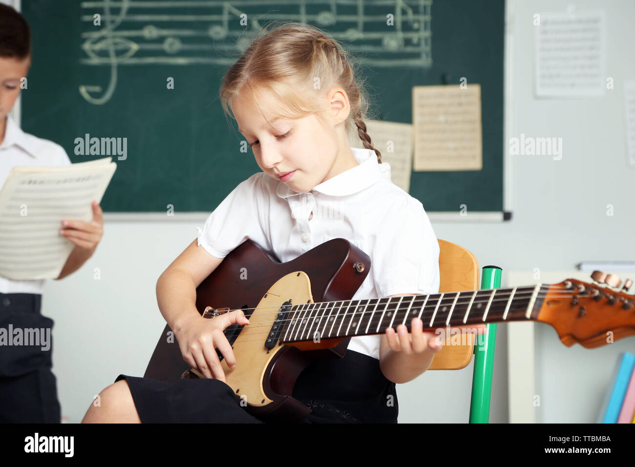 Cute pupils having music lesson in classroom at elementary school Stock ...