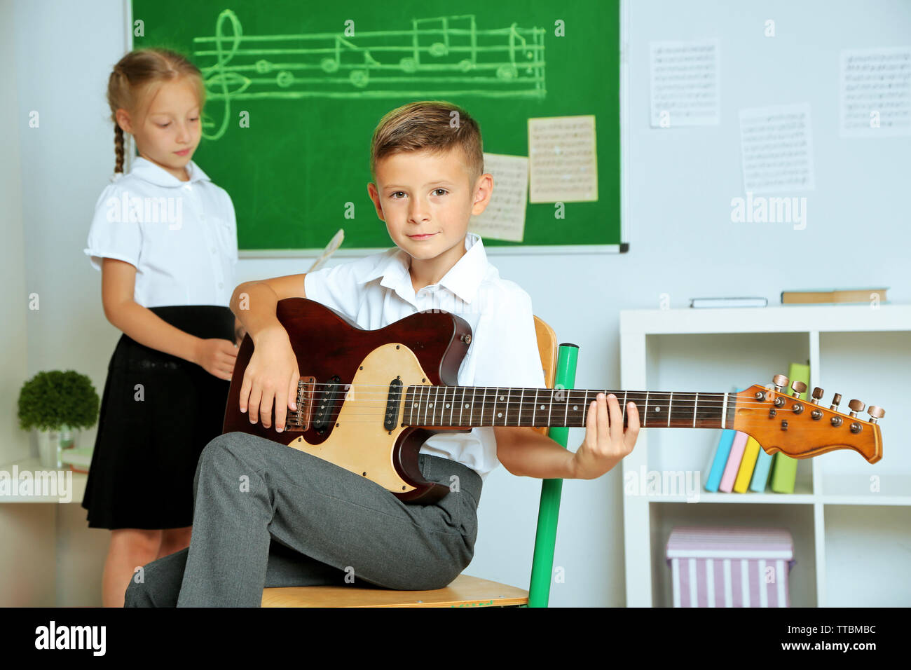 Cute pupils having music lesson in classroom at elementary school Stock ...