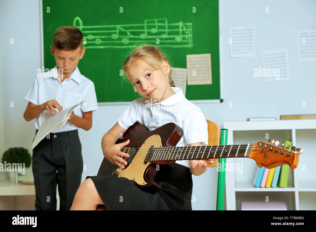 Cute pupils having music lesson in classroom at elementary school Stock ...
