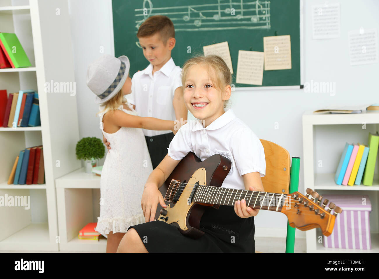 Cute pupils having music lesson in classroom at elementary school Stock ...