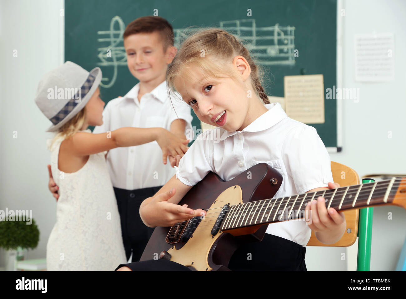 Cute pupils having music lesson in classroom at elementary school Stock ...