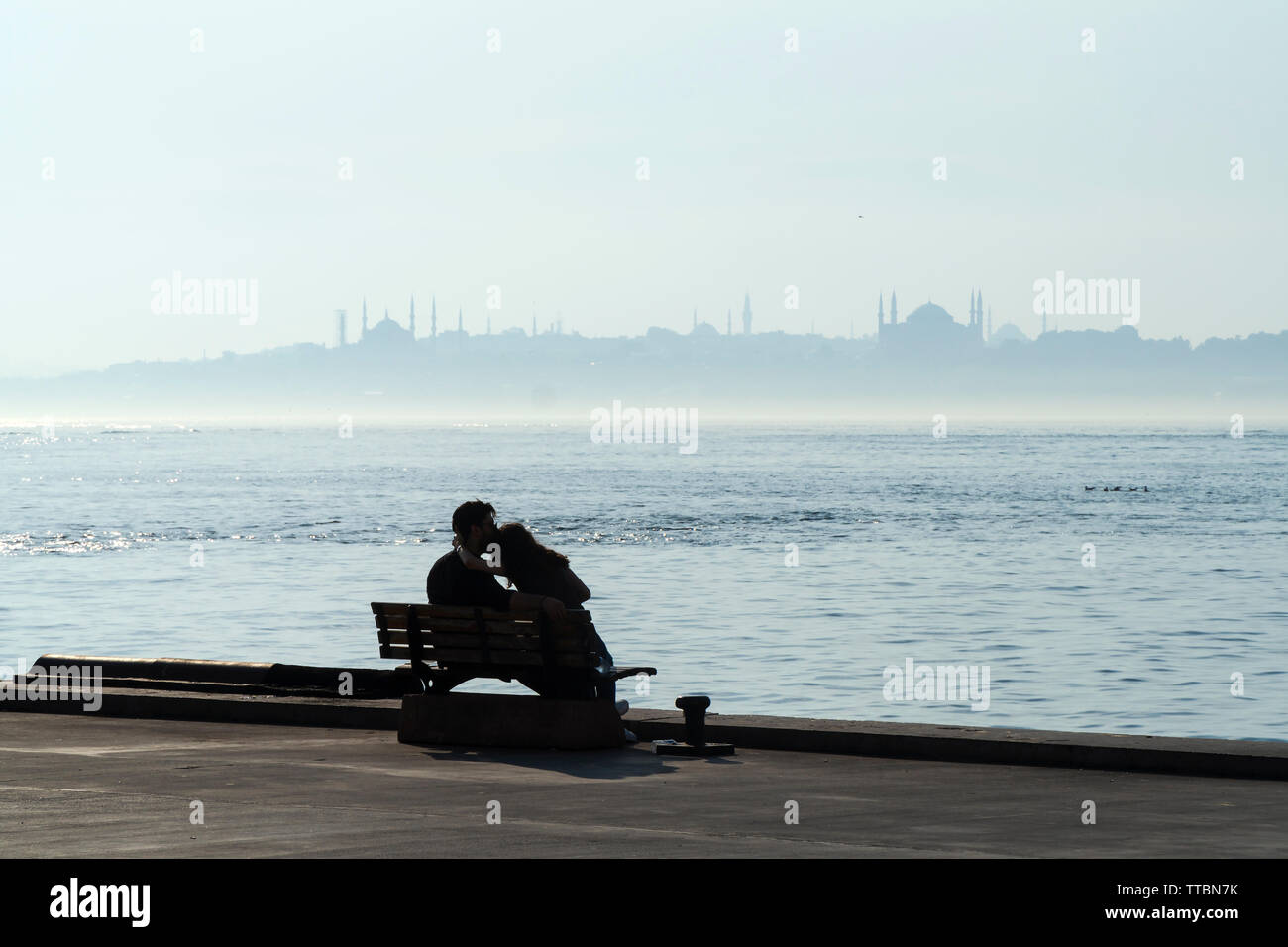 Istanbul, Turkey - June 12, 2019: Young lovers are sitting and kissing ...