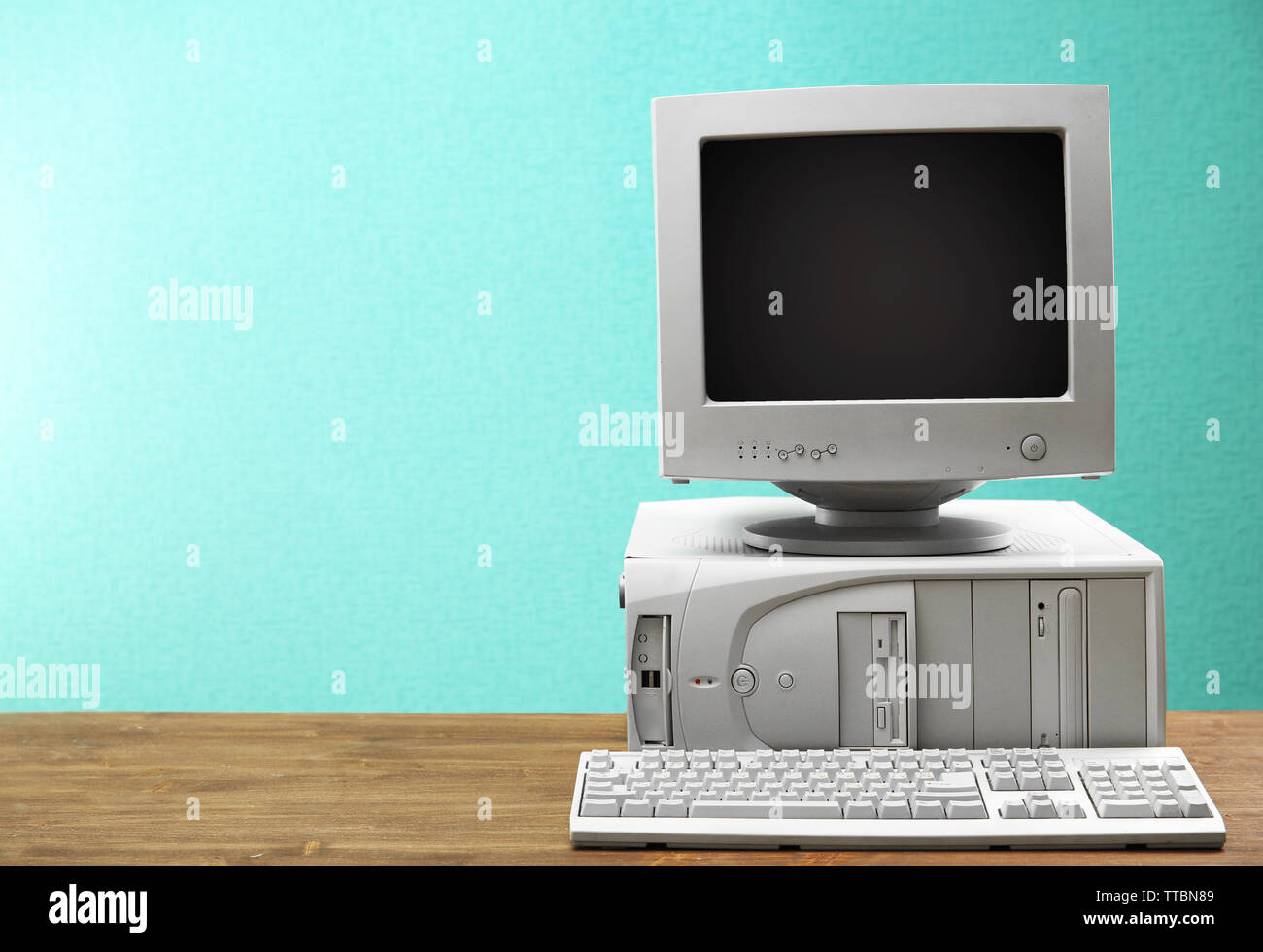 Obsolete computer set on light blue background Stock Photo - Alamy