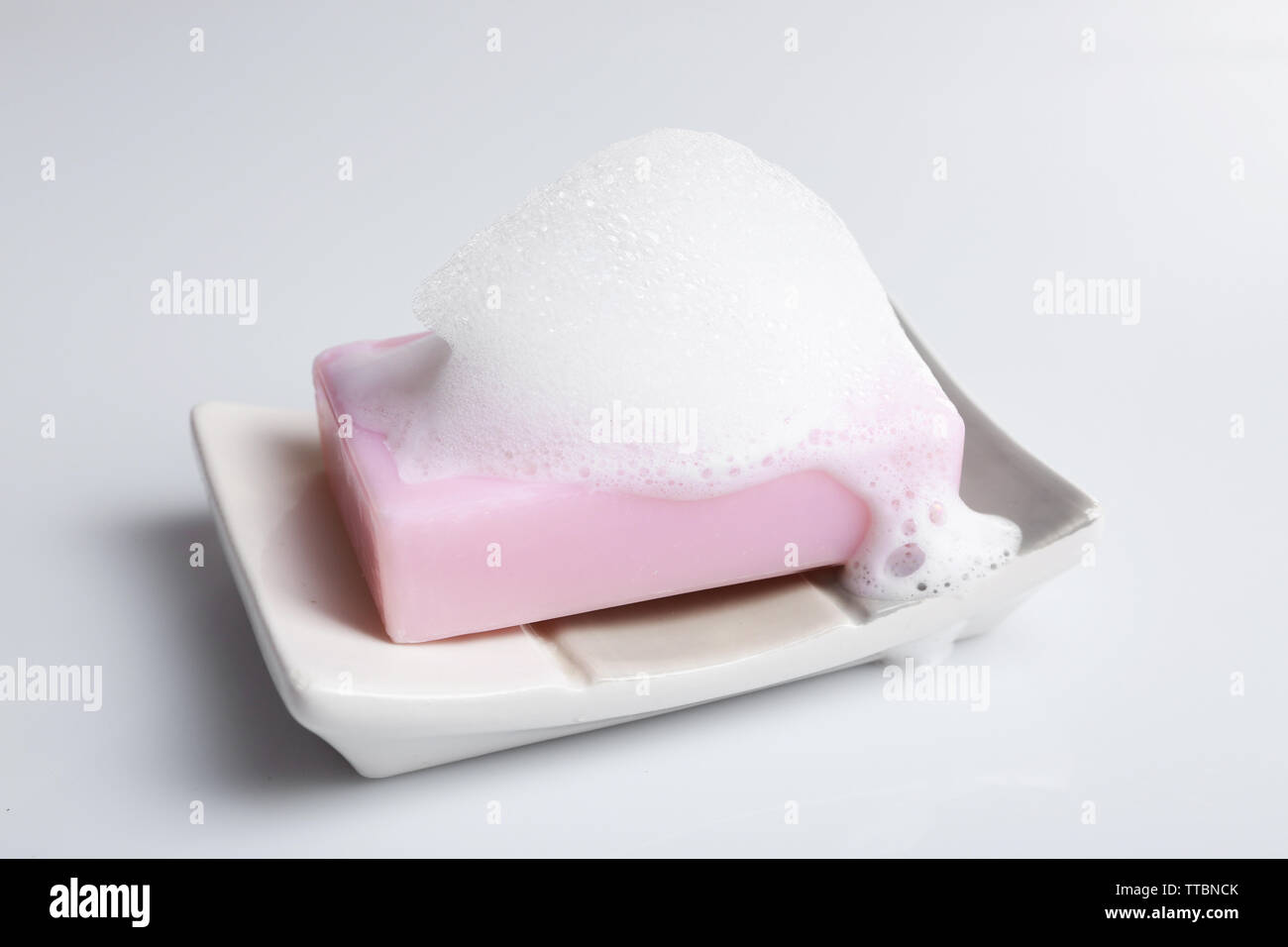 Soap with foam isolated on white Stock Photo - Alamy