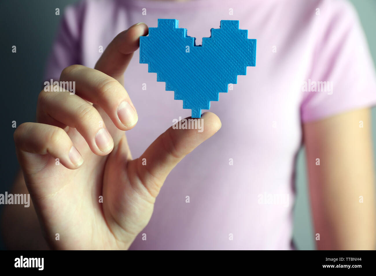 Closeup of plastic puzzle heart in female hand Stock Photo - Alamy