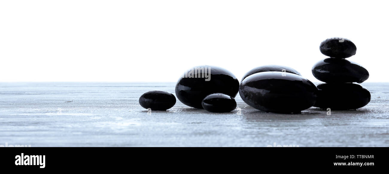 Wet spa stones isolated on white Stock Photo - Alamy