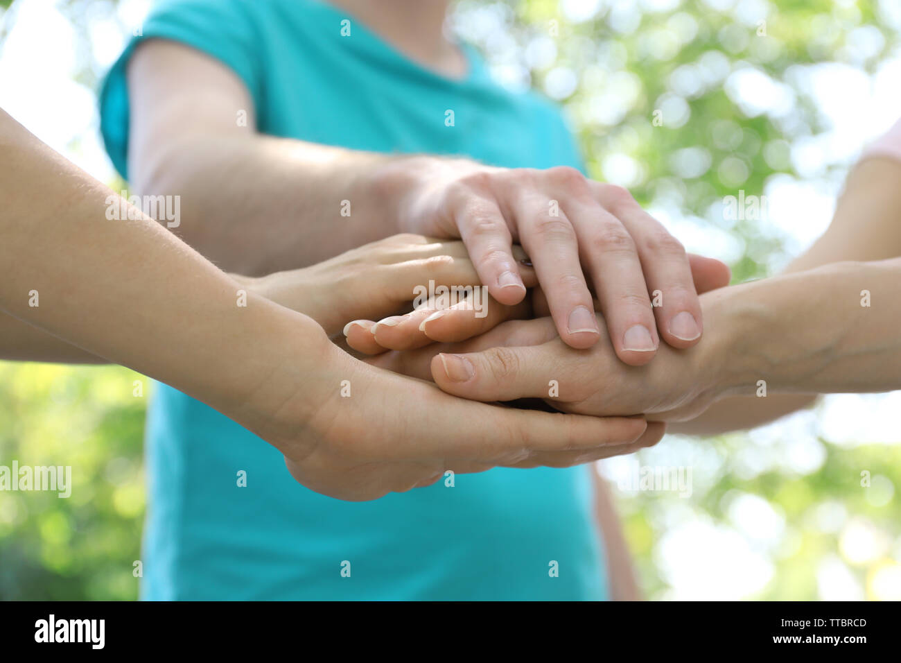 United hands outdoors Stock Photo - Alamy