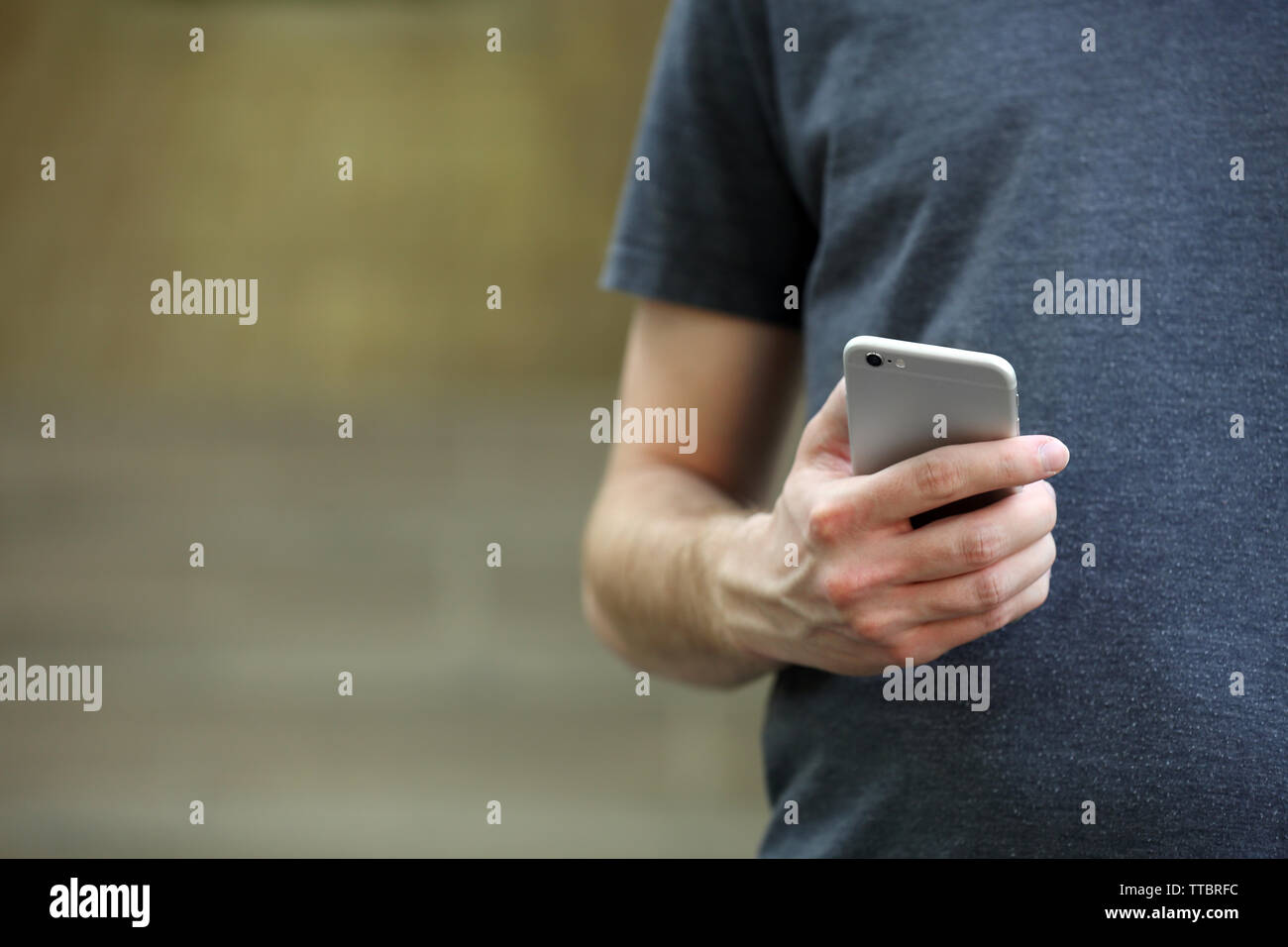 Man holding smart mobile phone outdoors Stock Photo - Alamy