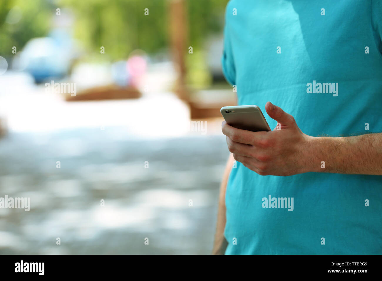 Man holding smart mobile phone outdoors Stock Photo - Alamy