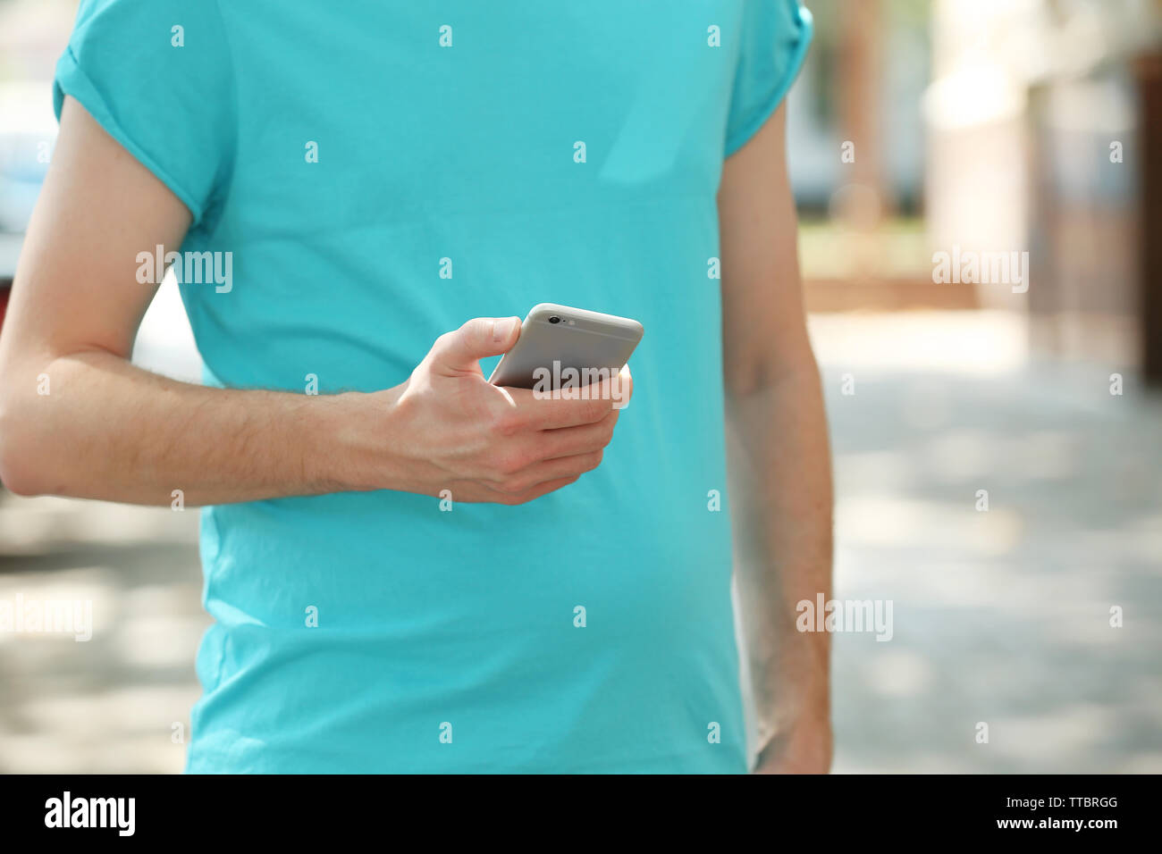 Man holding smart mobile phone outdoors Stock Photo - Alamy