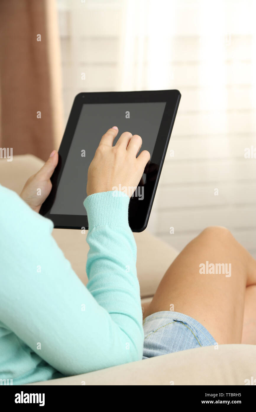 Female hand holding PC tablet on home interior background Stock Photo ...