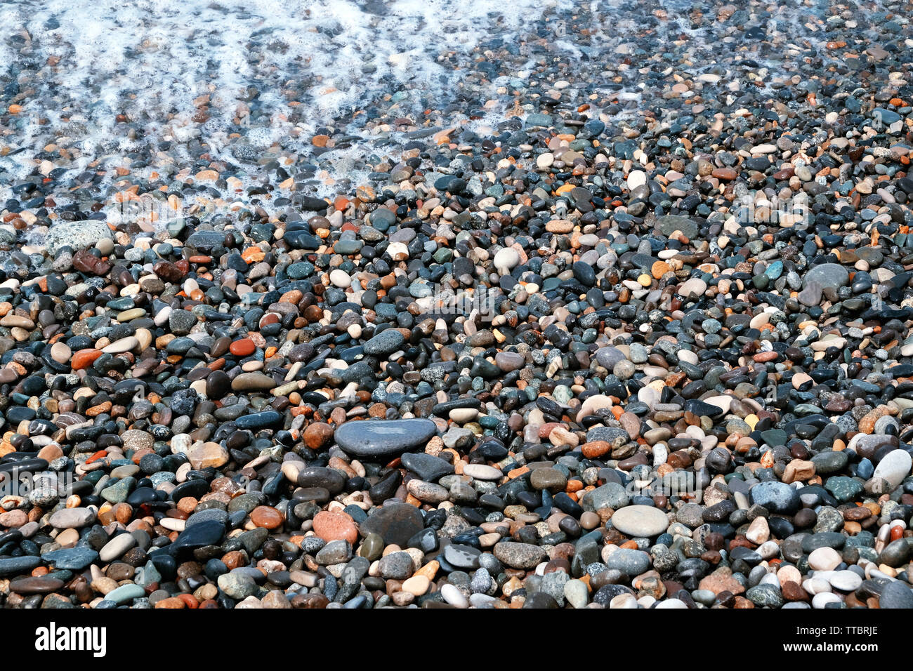 Wet pebbles on sea beach Stock Photo - Alamy