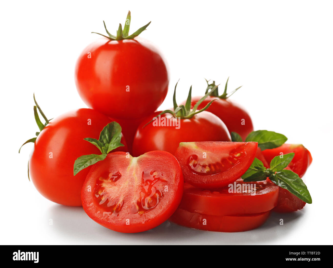 Whole and cut tomatoes isolated on white Stock Photo - Alamy