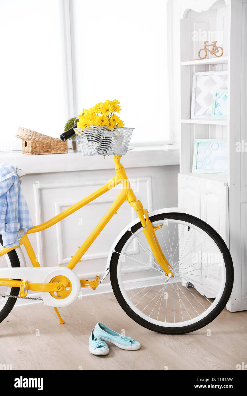 Yellow retro bicycle in spacious bright room Stock Photo - Alamy