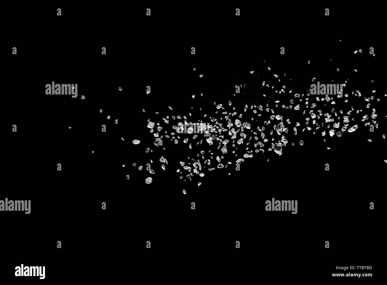 Split debris of stone exploding against black background Stock Photo ...