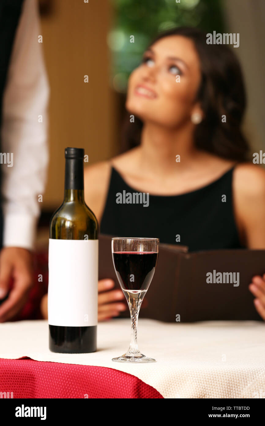 Young pretty lady at the restaurant. Waiter takes menu Stock Photo - Alamy