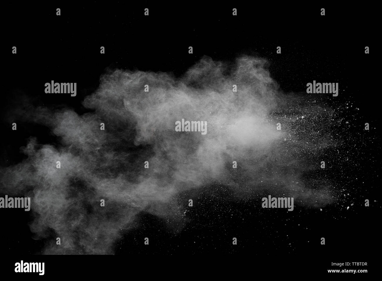 White powder explosion.Freeze motion of white dust particles on black ...