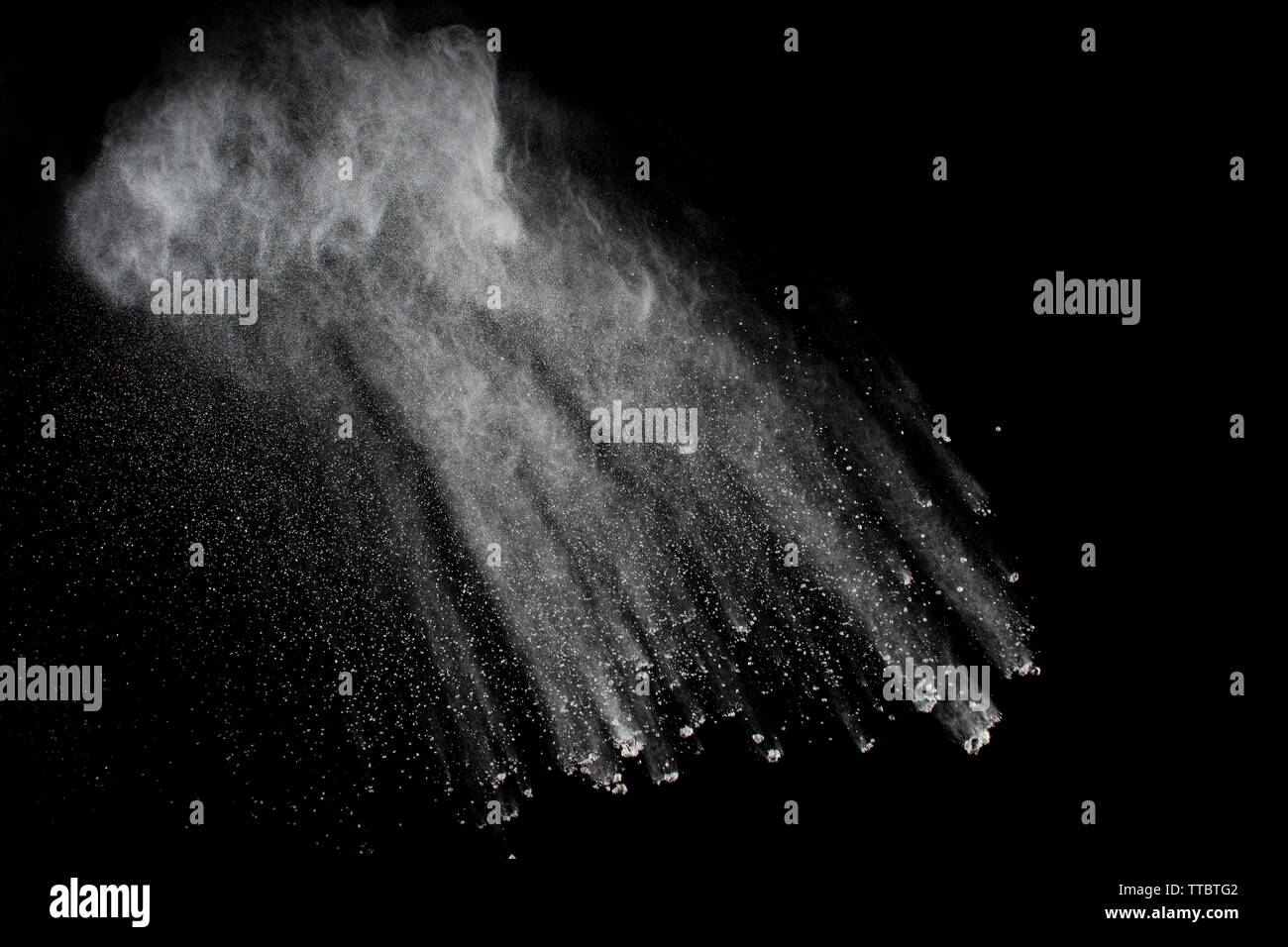 White powder explosion.Freeze motion of white dust particles on black ...