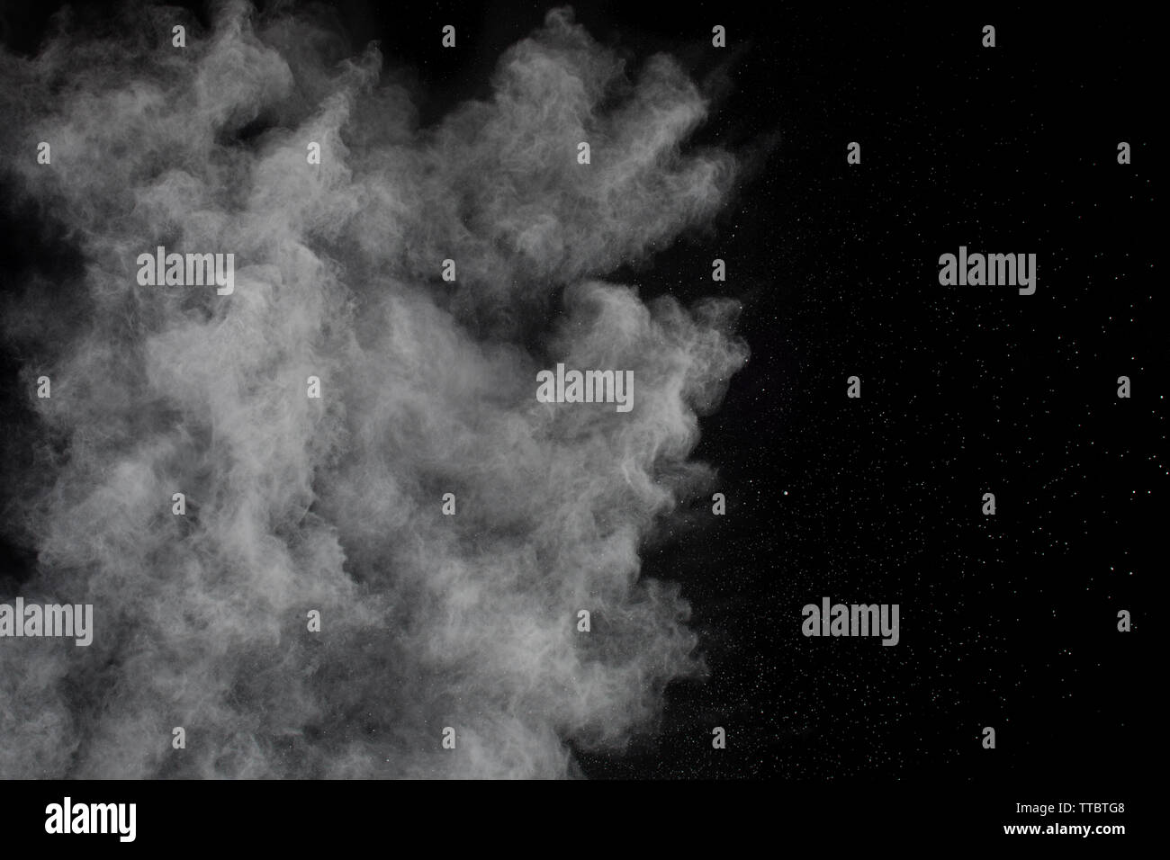 White powder explosion.Freeze motion of white dust particles on black ...