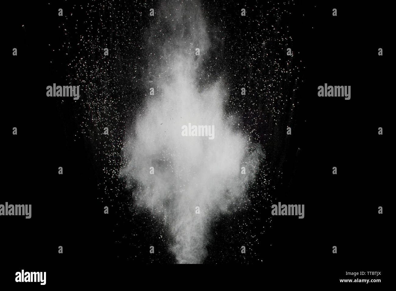 White powder explosion.Freeze motion of white dust particles on black ...