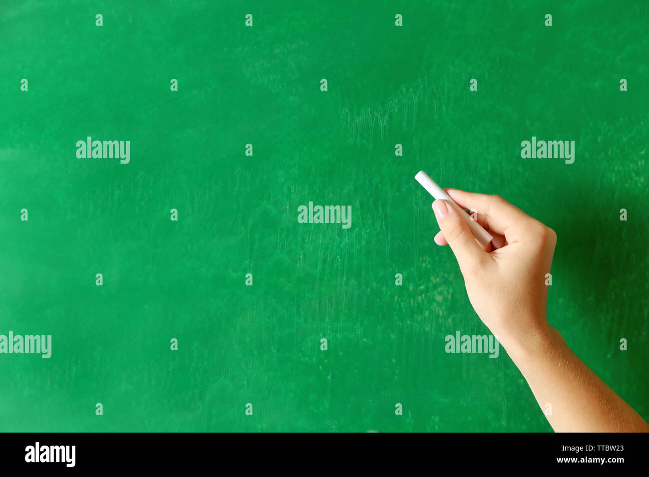 Female teacher pointing chalk hi-res stock photography and images - Alamy
