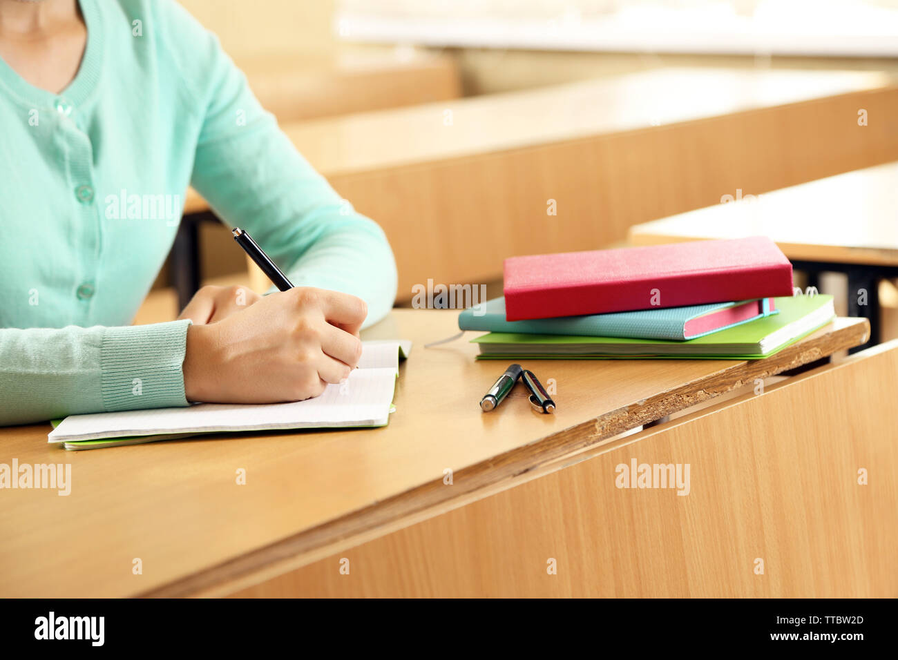Female hand writing in notebook, close-up Stock Photo - Alamy