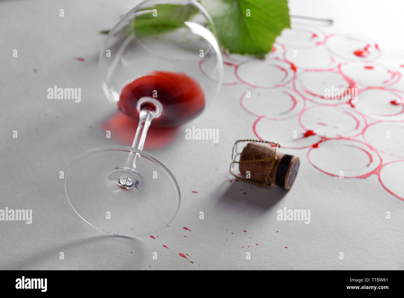 Grapes made with wine cork and goblet of spilled wine Stock Photo - Alamy