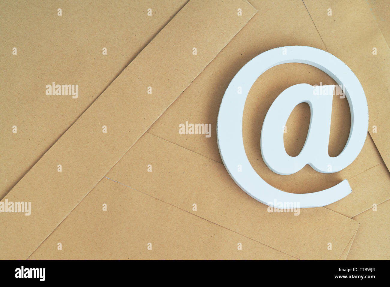 Email simbol at sign on brown envelopes background Stock Photo - Alamy