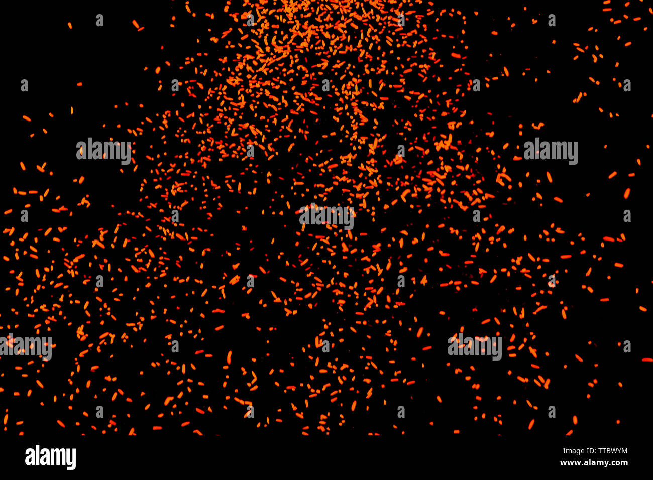 Random flying red orange color particles isolated on the black ...