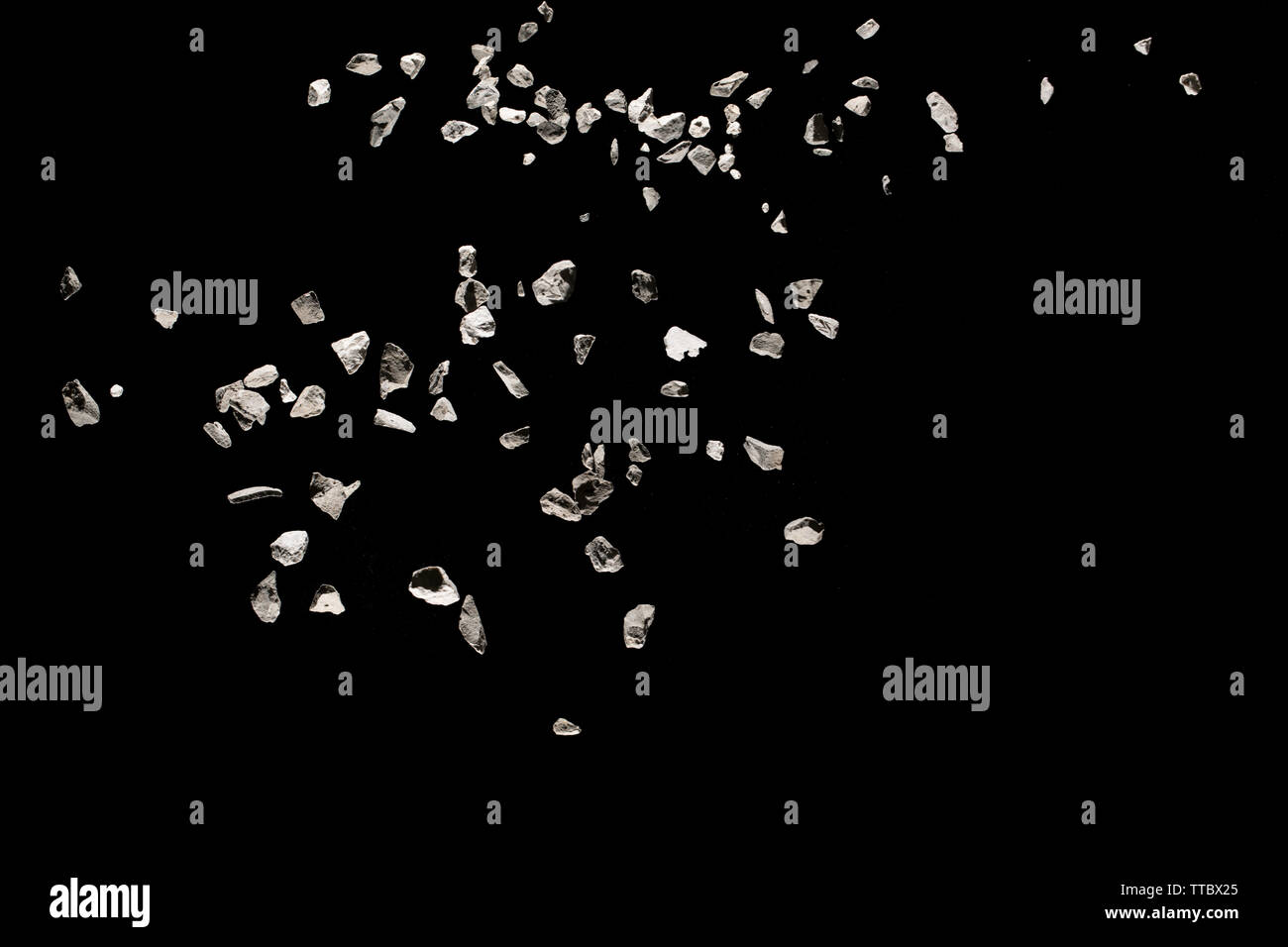 Split debris of stone exploding against black background Stock Photo ...