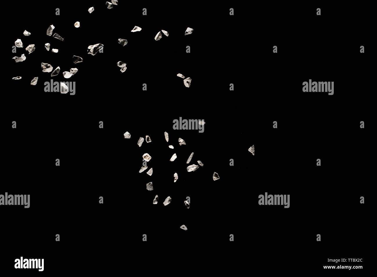 Split debris of stone exploding against black background Stock Photo ...