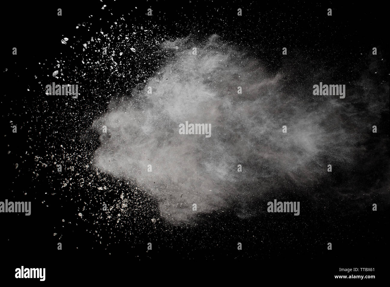 White powder explosion.Freeze motion of white dust particles on black ...