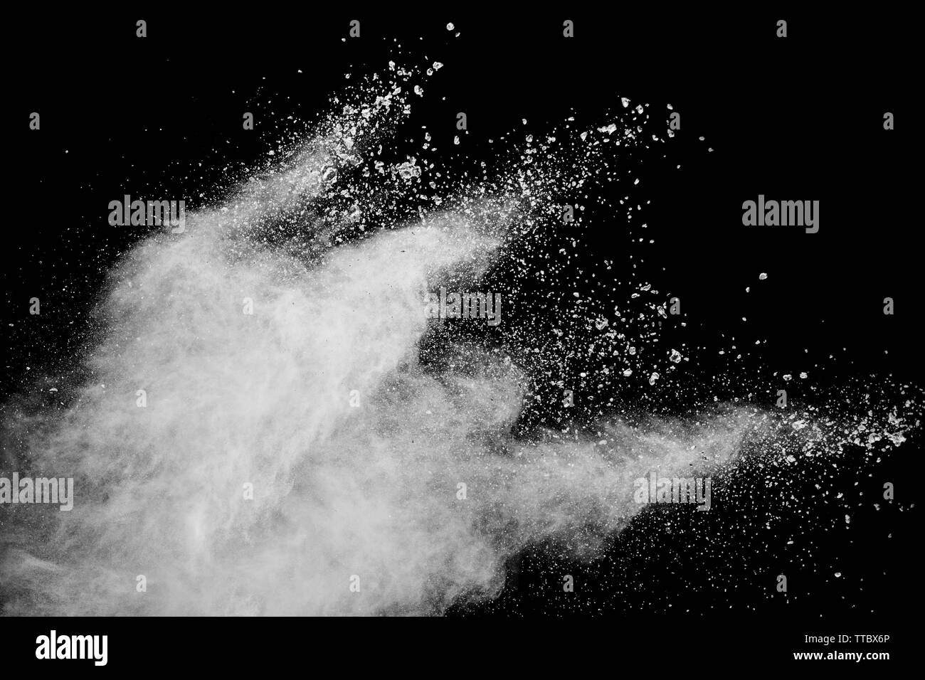White powder explosion.Freeze motion of white dust particles on black ...