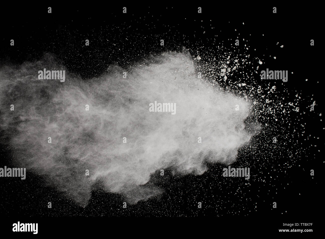 White powder explosion.Freeze motion of white dust particles on black ...
