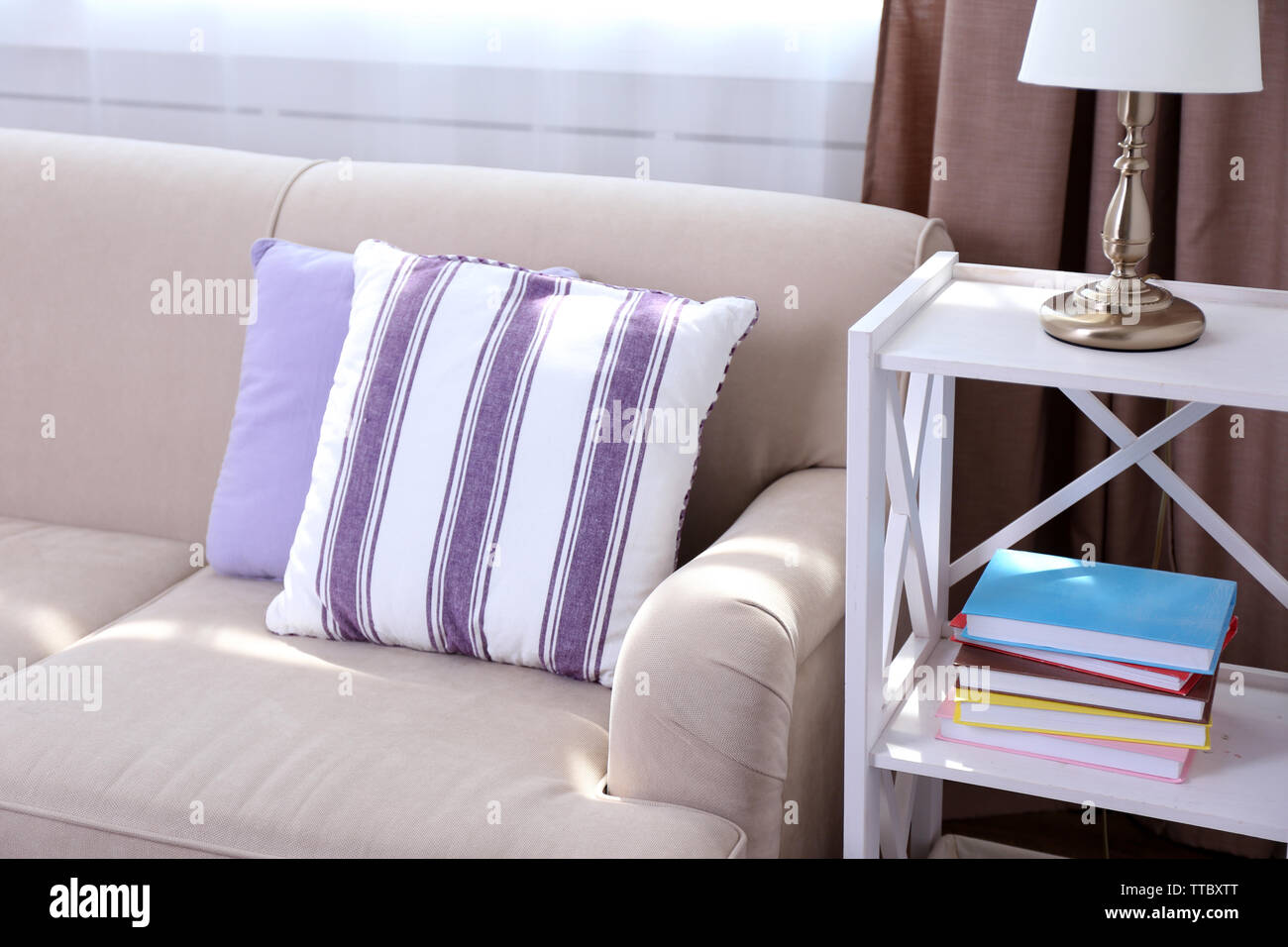 Pastel color room interior with comfortable sofa and pillows, close up ...