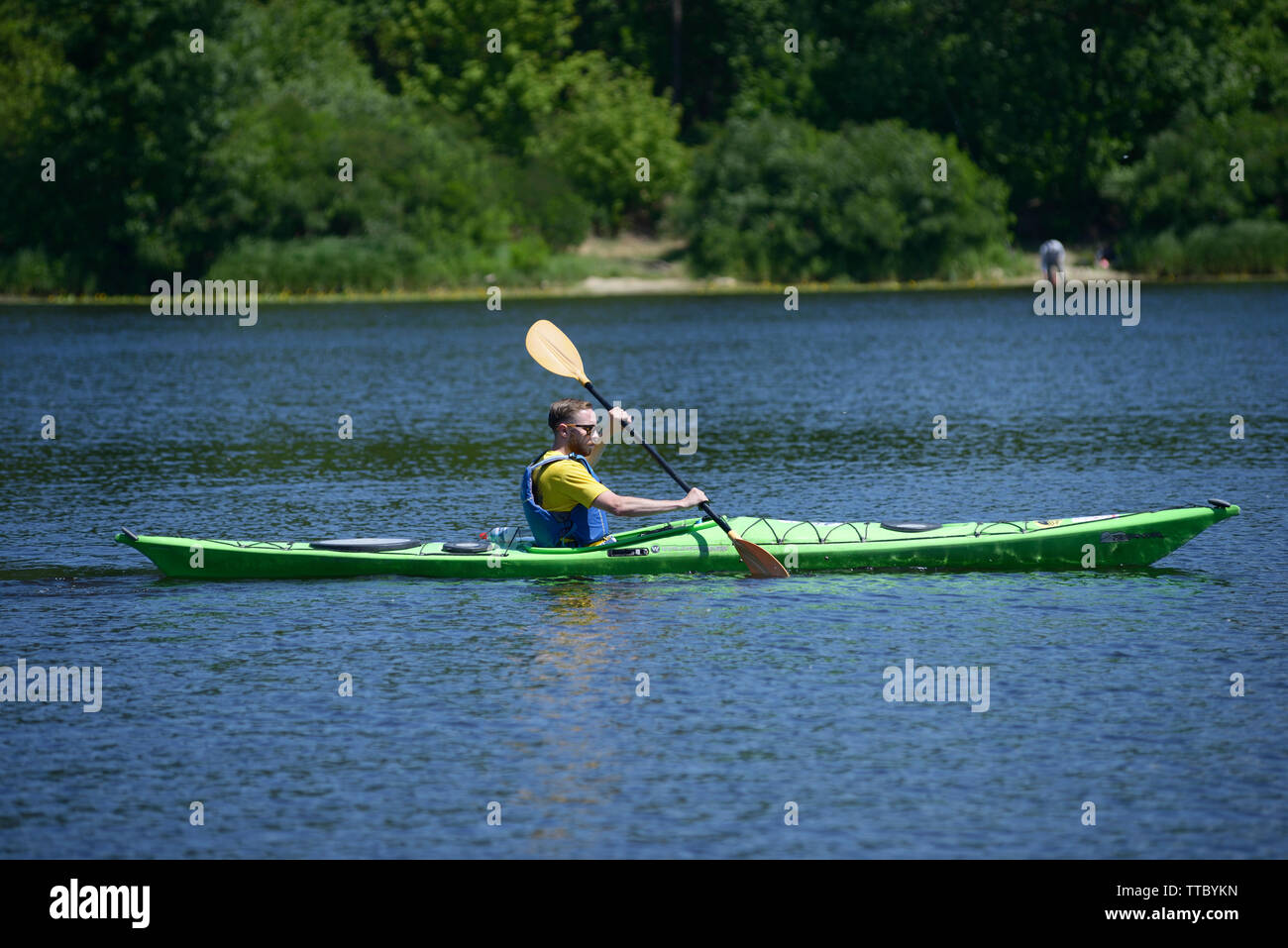 Man oarsman rowing canoe on a river. May 25, 2019. Kiev, Ukraine Stock ...